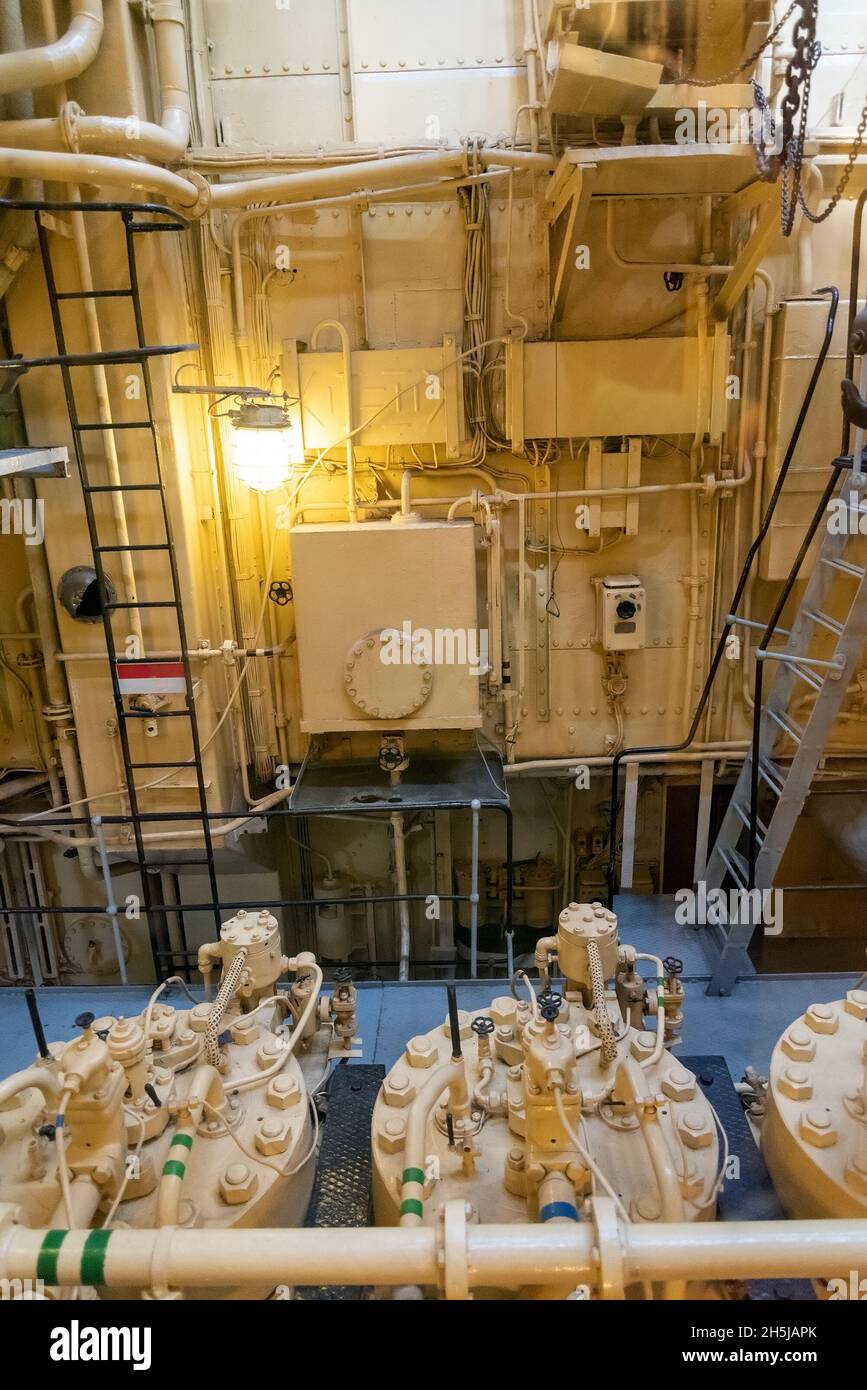 Yellow engine mounted on ship. Engine room on a old cargo boat ship ...