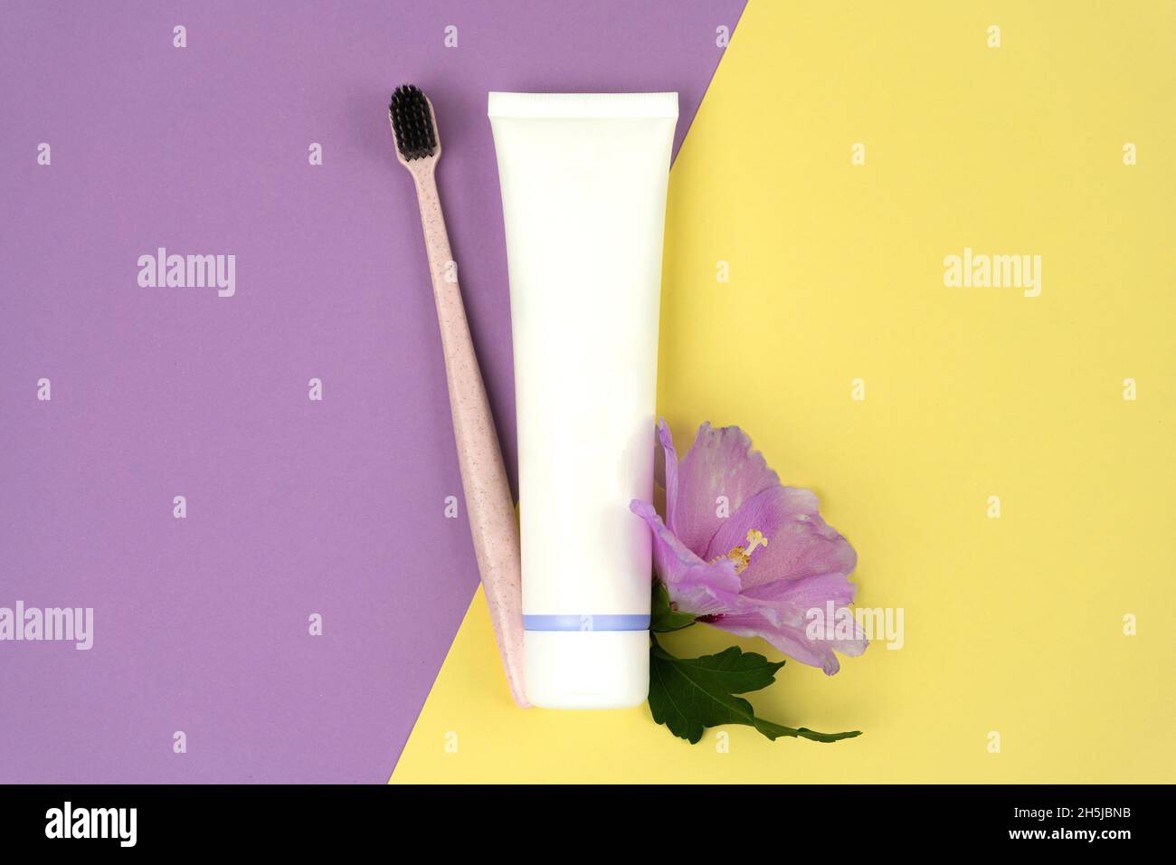 Tube of toothpaste with a toothbrush made of recycled plastic with ...