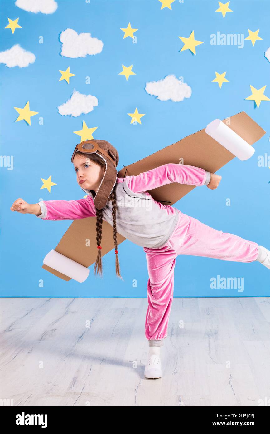 Girl pilot playing with toy jet pack at home. Success and leader ...