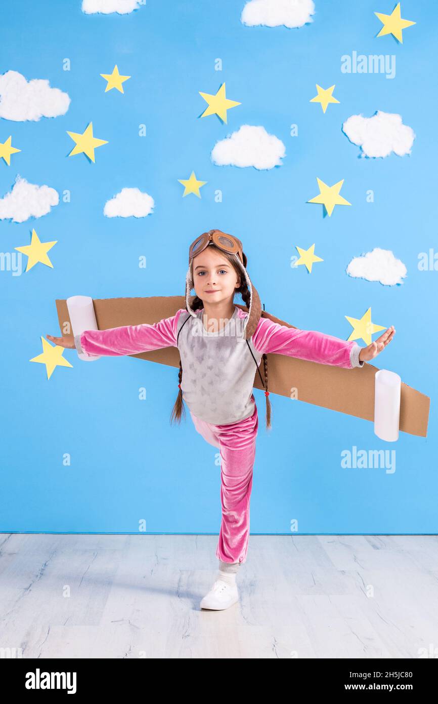 Girl pilot playing with toy jet pack at home. Success and leader ...