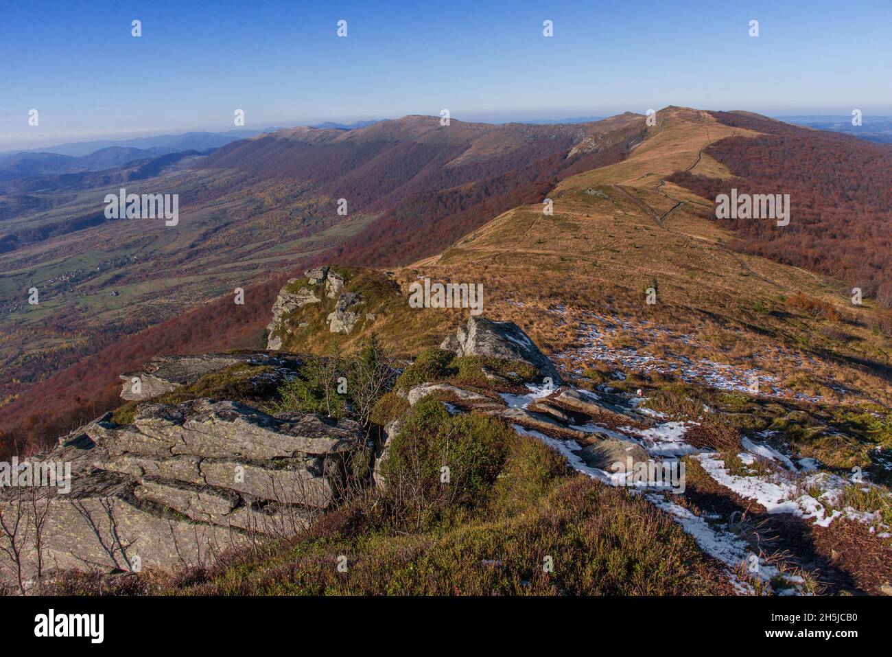 View of hills of Water Dividing ridge covered in red, orange and yellow ...