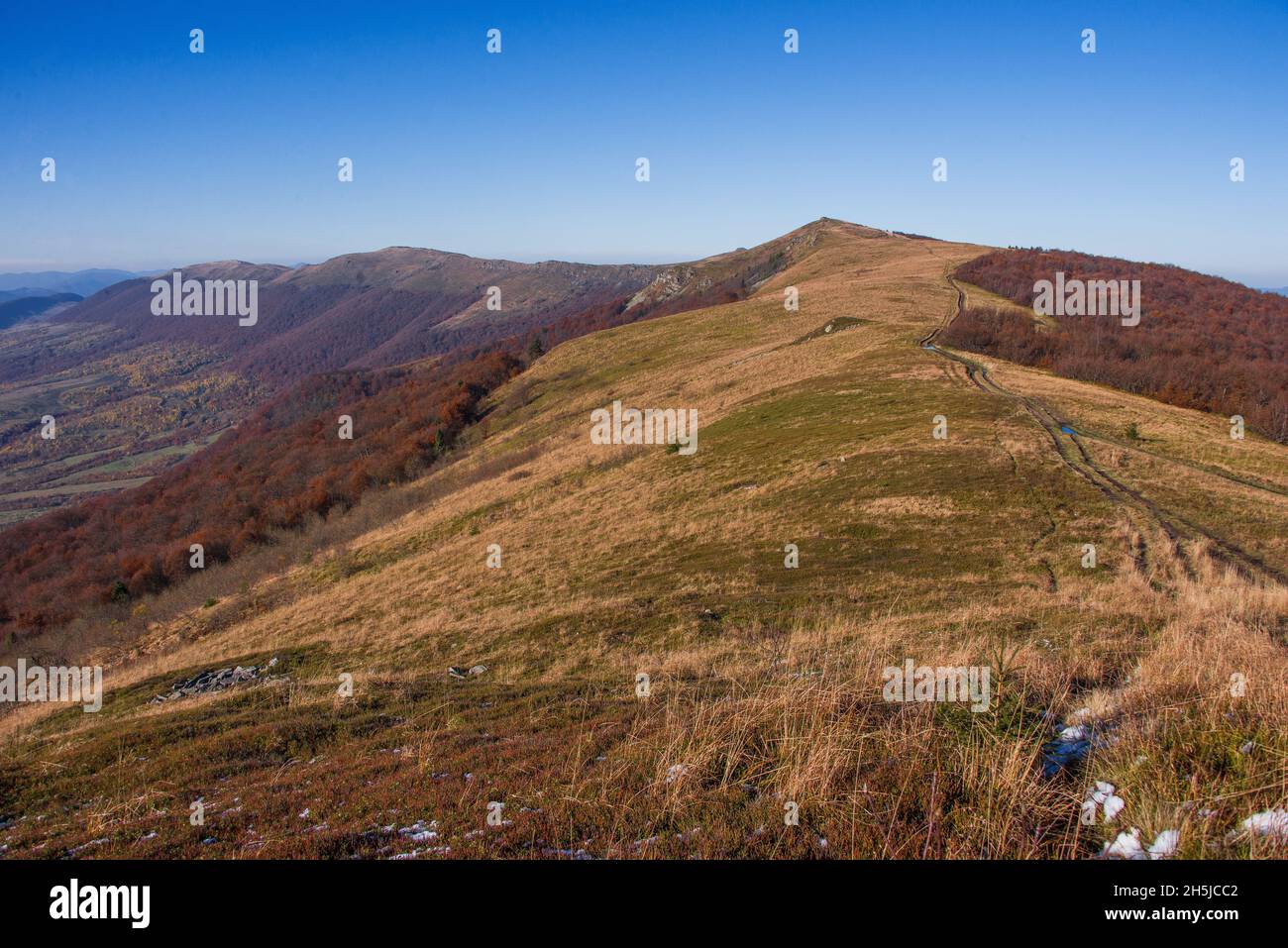 View of hills of Water Dividing ridge covered in red, orange and yellow ...