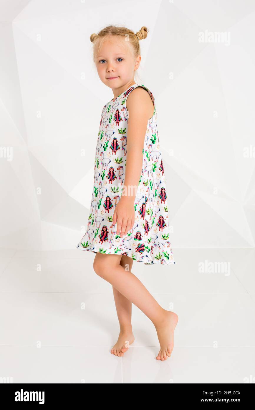 Beautiful little fashion model on white studio background. Portrait of ...