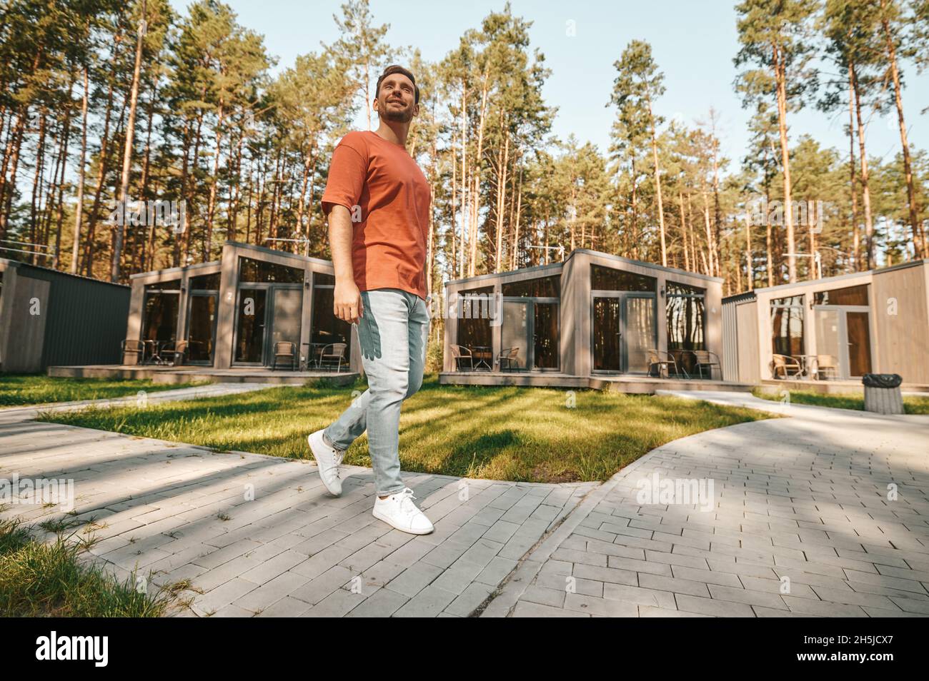 Smiling man walking in nature recreation area Stock Photo - Alamy