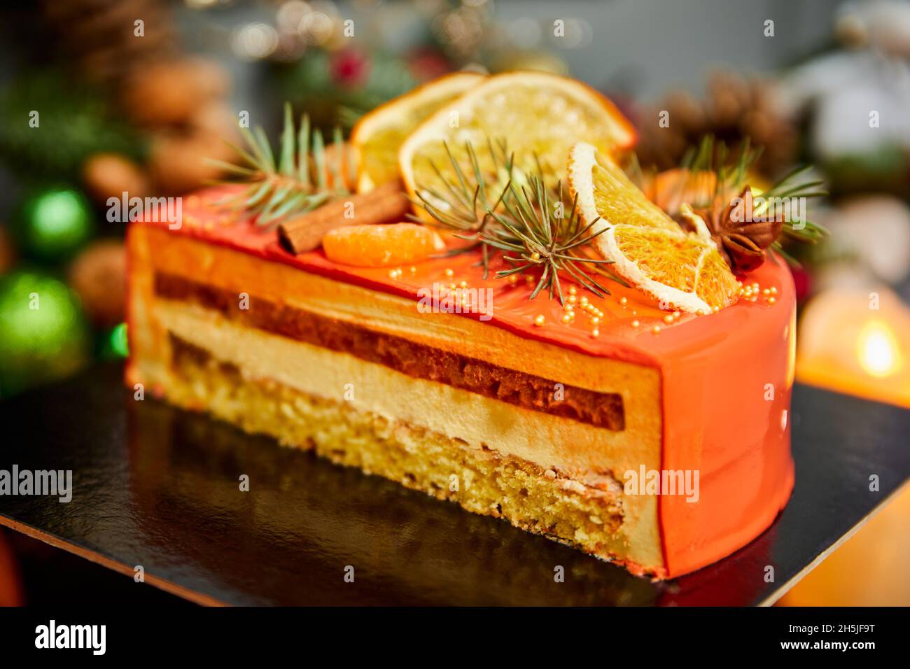 Christmas mousse apricot cutted cake with vanilla biscuit decorated ...