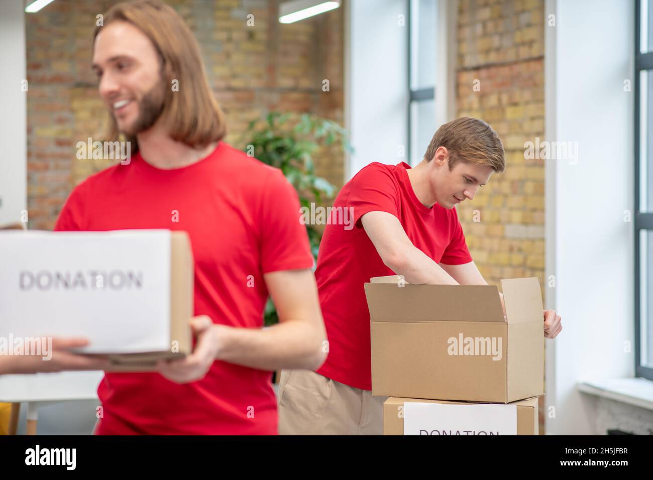 Volunteers working in a sorting point and looking busy Stock Photo - Alamy Volunteers working in a sorting point and looking busy Stock Photo - Alamy