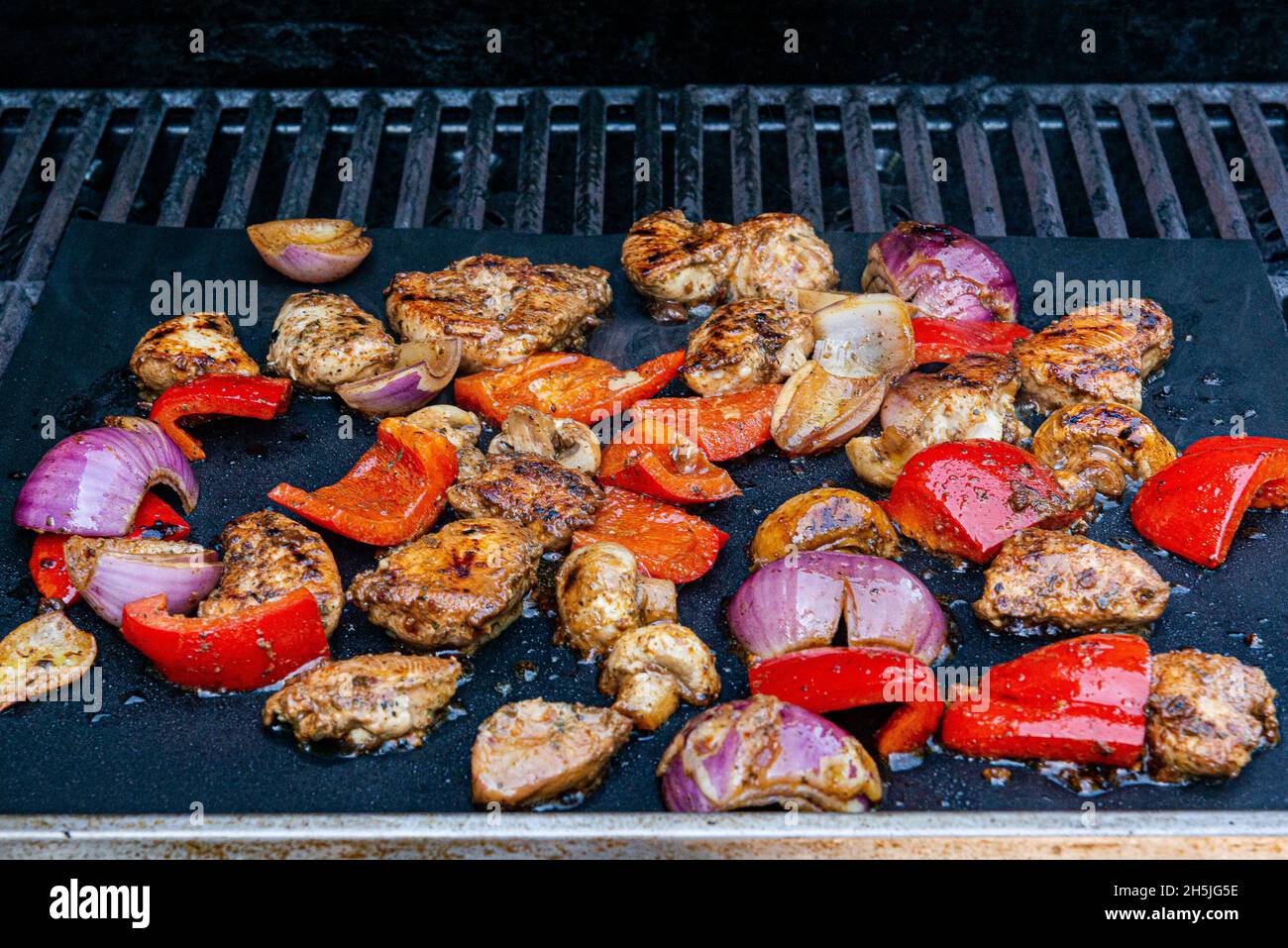 meat and vegetables sautéed on the bbq-3 Stock Photo - Alamy