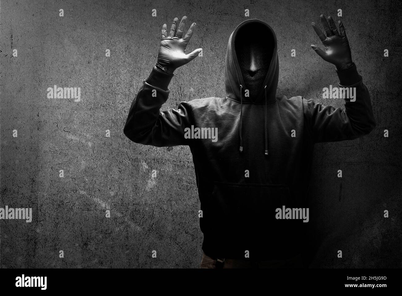 A criminal man in a hidden mask raised a hand for arrested with black ...