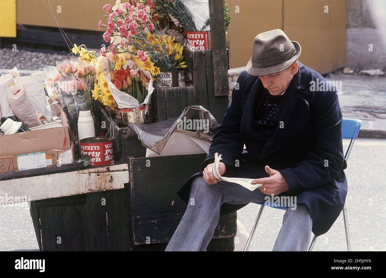 London 1982. A street view of a flower salesman. The tulips and flowers ...