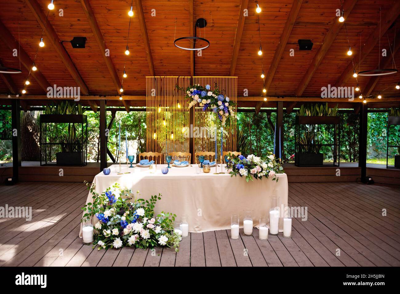 Wedding presidium, banquet table for newlyweds with flowers, greenery ...
