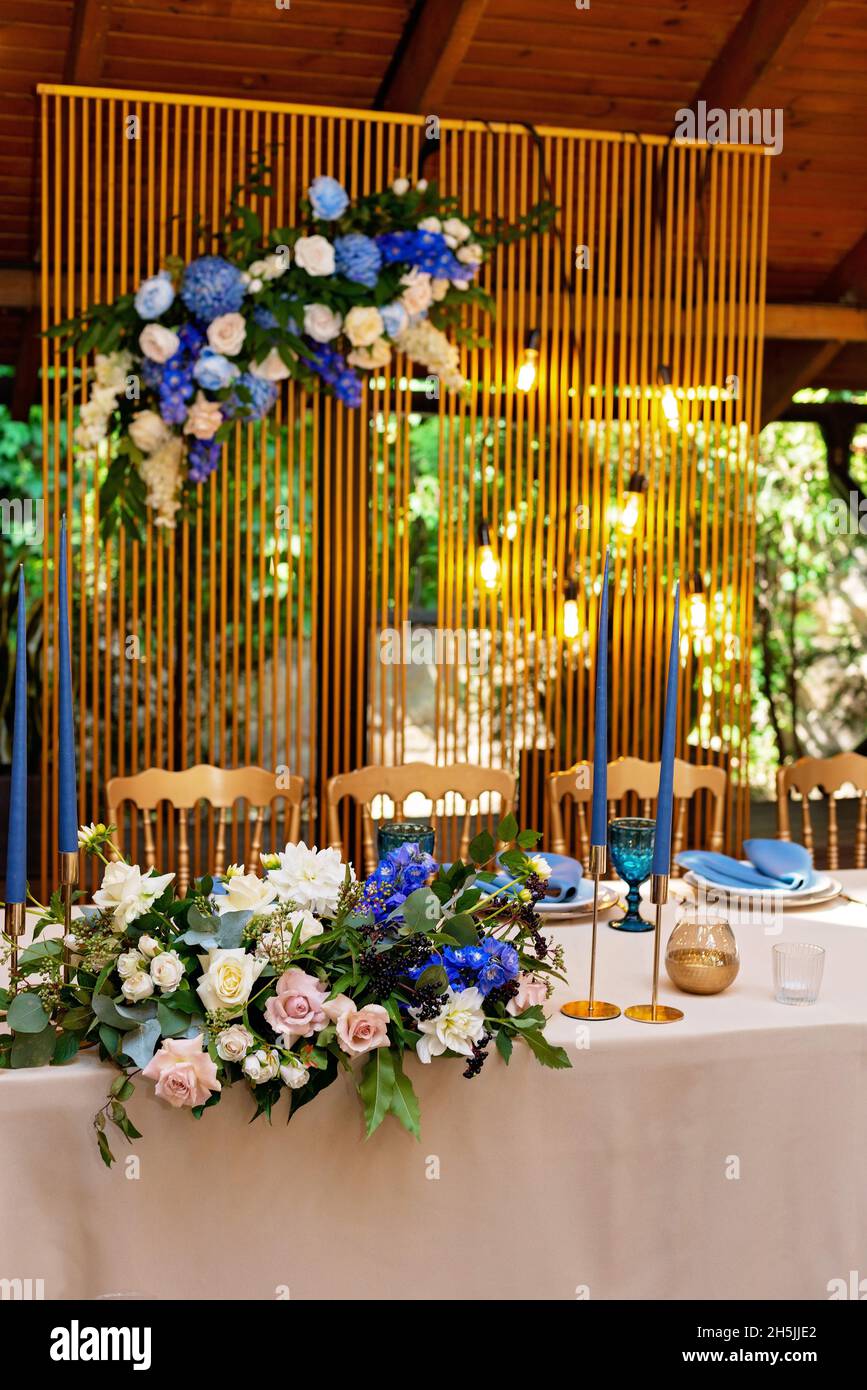 Wedding presidium, banquet table for newlyweds with flowers, greenery ...
