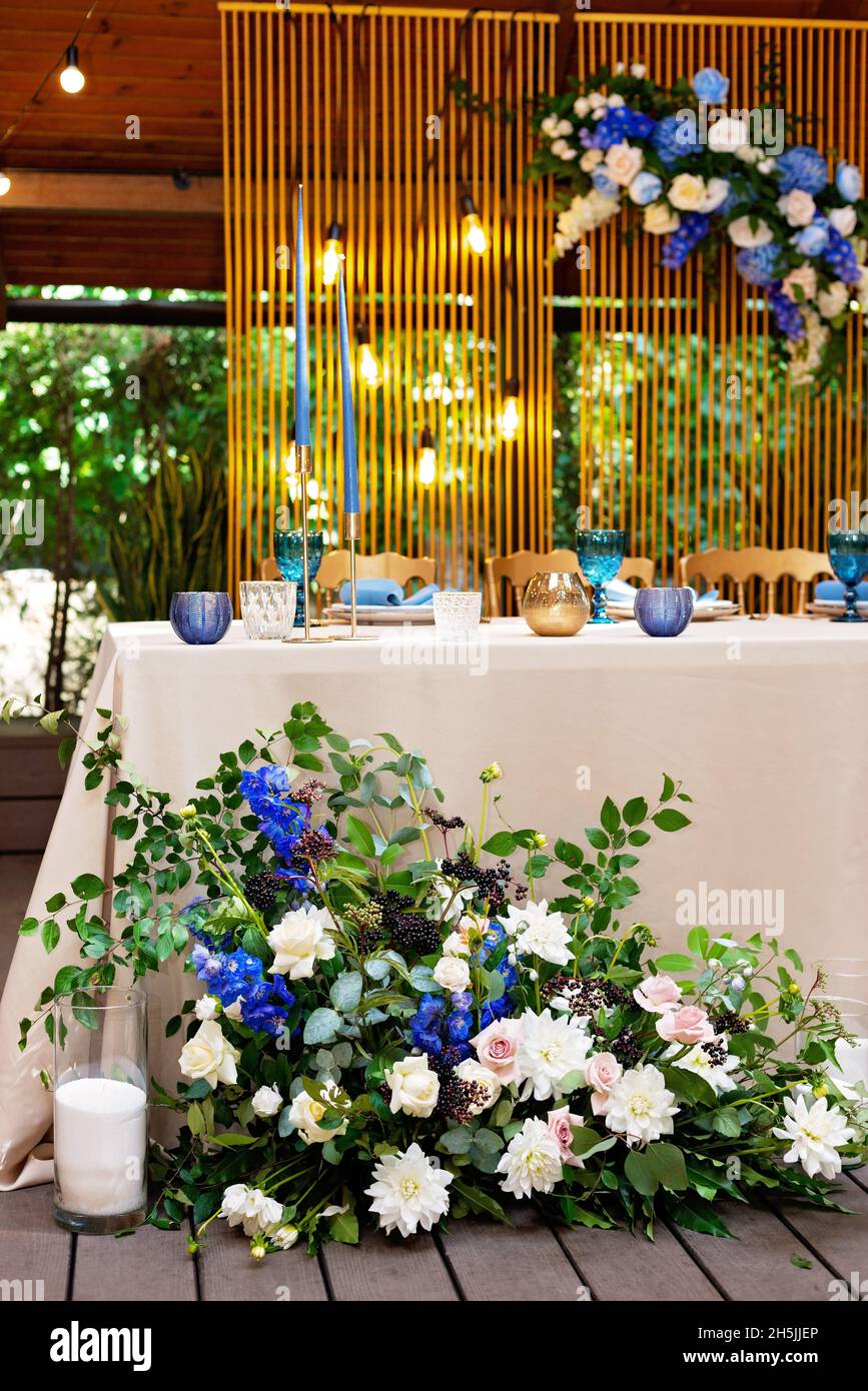 Wedding presidium, banquet table for newlyweds with flowers, greenery ...