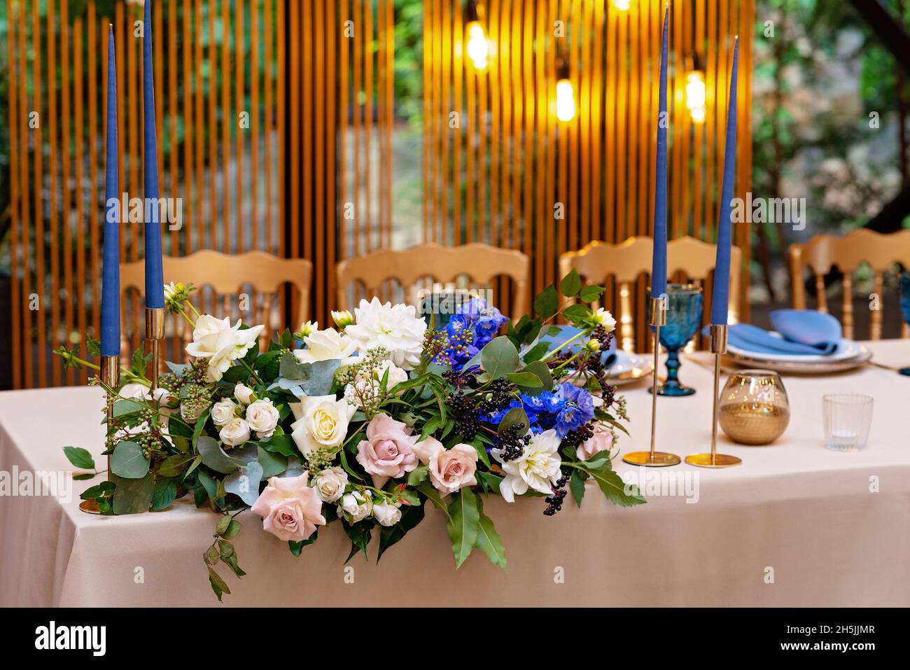 Wedding presidium, banquet table for newlyweds with flowers, greenery ...