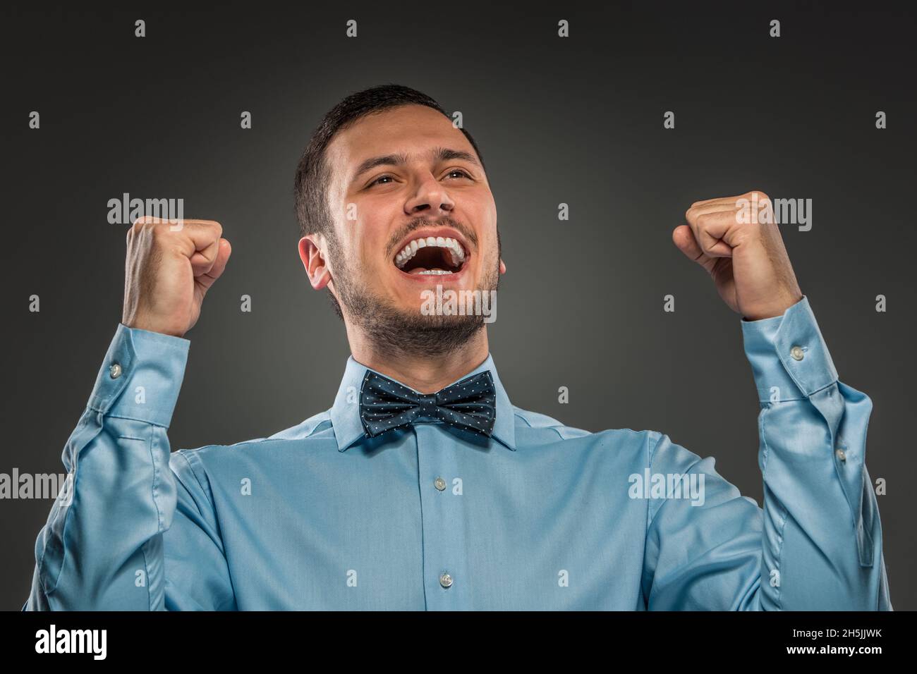 Portrait excited, happy man, arms up fists pumped celebrating su Stock ...