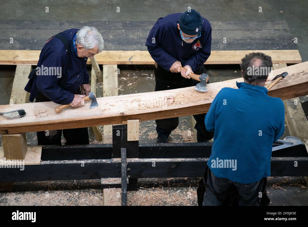 A team of volunteers work on the keel of the 88ft-long replica of the ...
