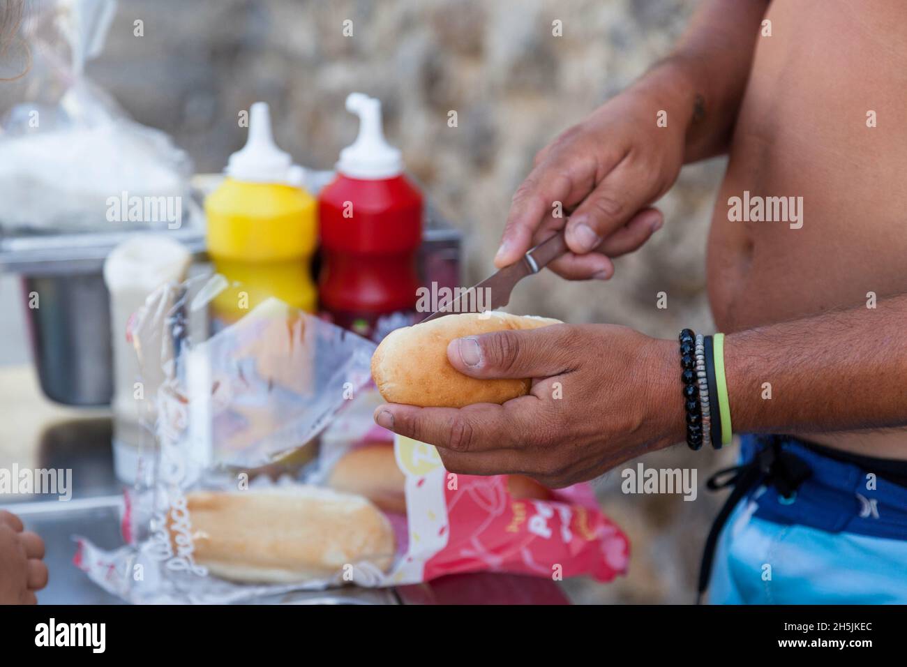 Man eating hamburger standing hi-res stock photography and images - Alamy