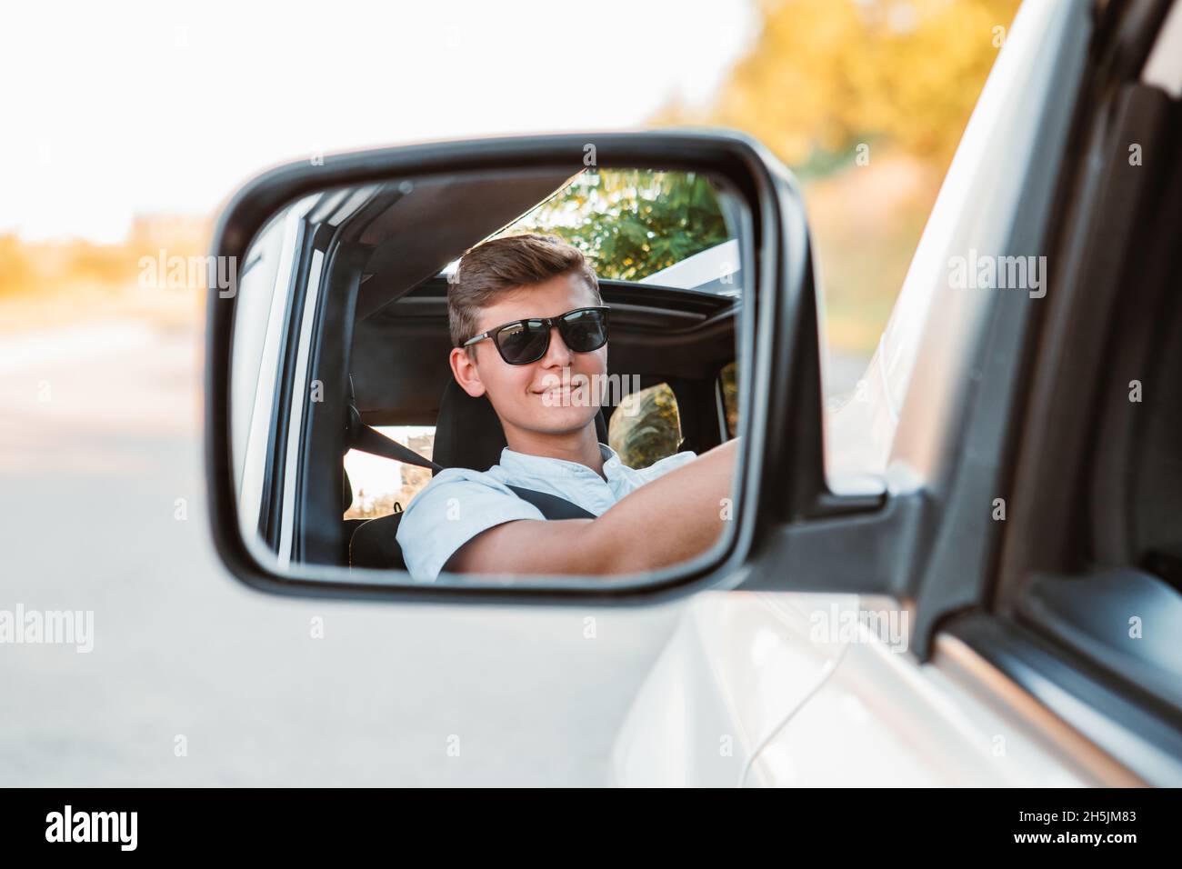 young handsome confident man driving car. road trip Stock Photo - Alamy