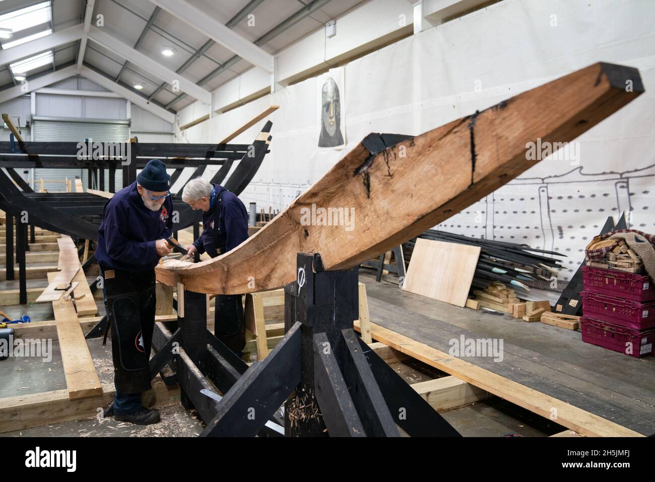Bryan Knibbs (left) and David Turner work on the keel of the 88ft-long ...