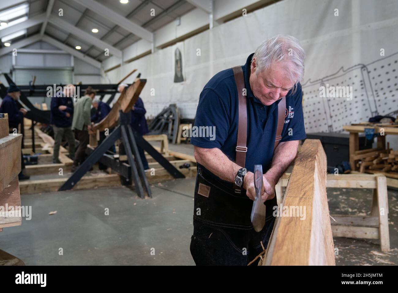 A team of volunteers work on the keel of the 88ft-long replica of the ...