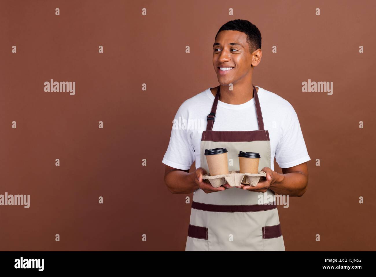 Photo of funny young brunet waiter guy hold beverages look advert wear ...