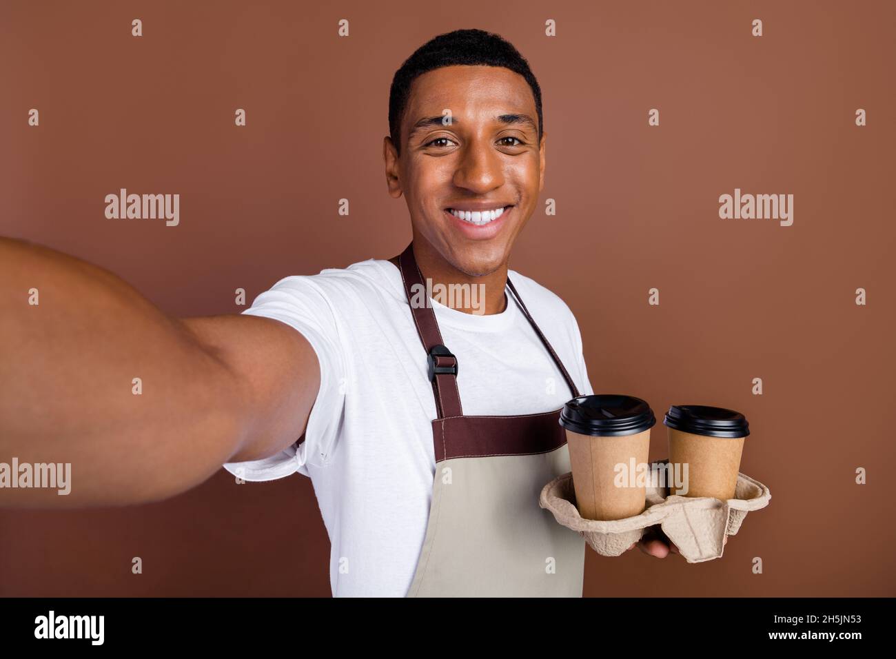 Photo of young african guy part-time occupation hold cup latte cacao ...