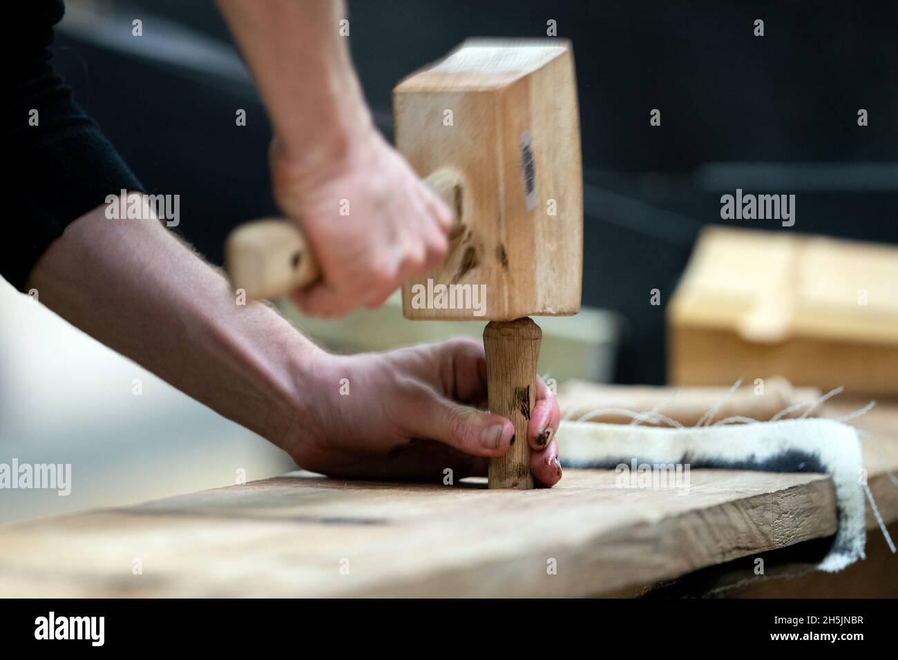 A treenail is hammered in to join the first two parts of the keel on ...