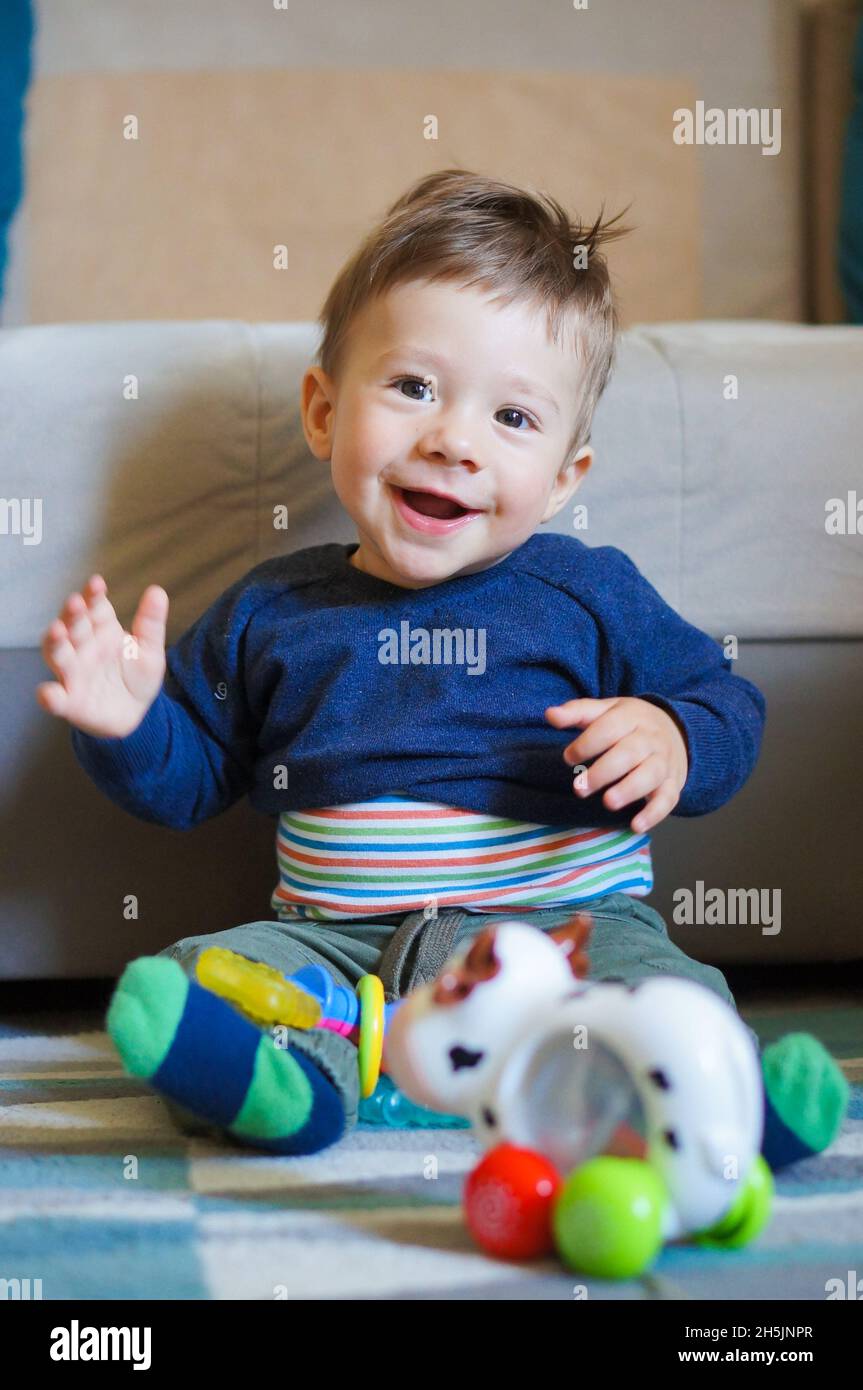 Happy little kid playing with toys and having fun Stock Photo - Alamy