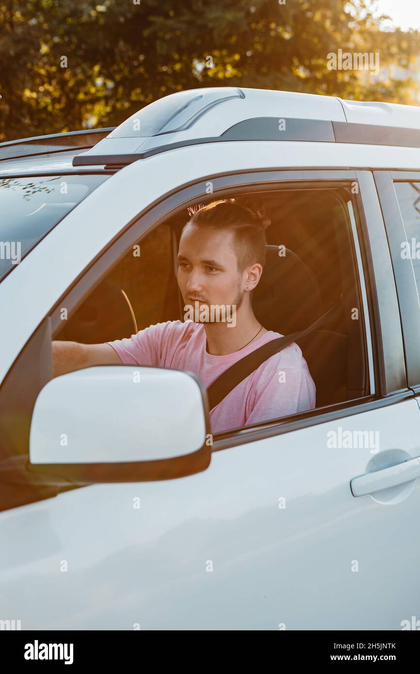 young handsome confident man driving car. road trip Stock Photo - Alamy