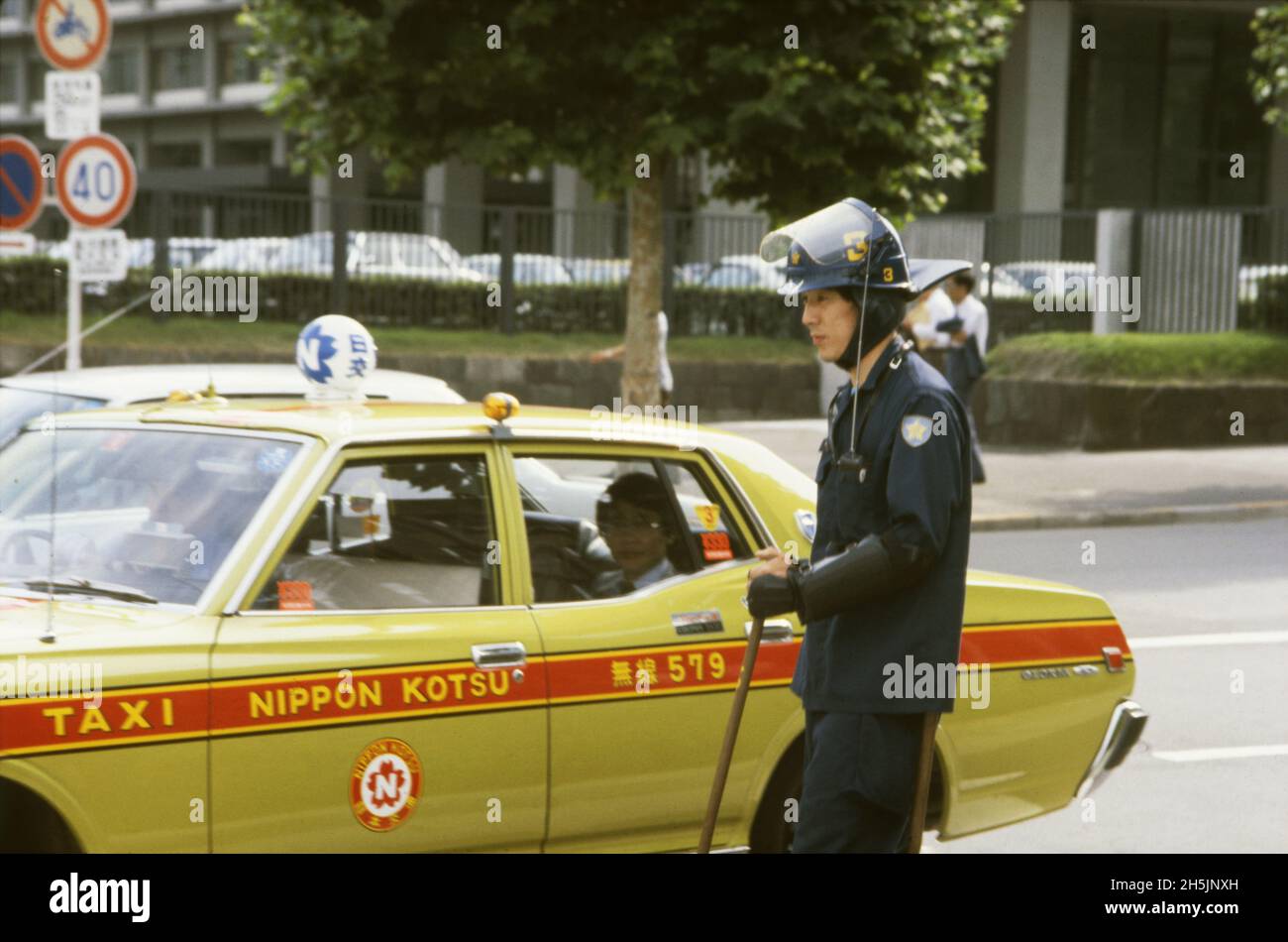 A policeman patrolling on a street in Tokyo. Japan, 1970s Stock Photo ...