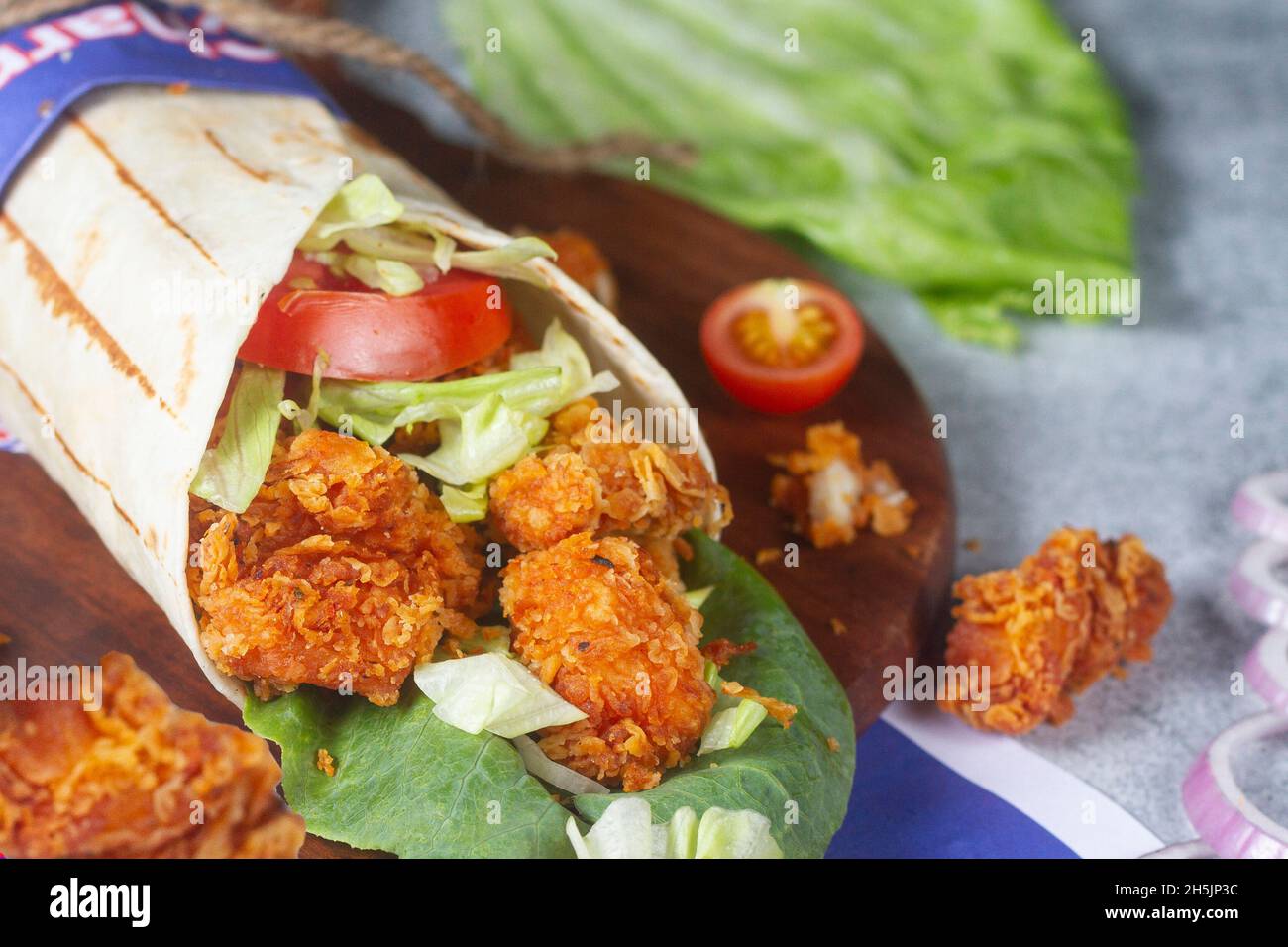 Fresh chicken popcorn roll with fresh tomatos, salad, cheese and onions ...