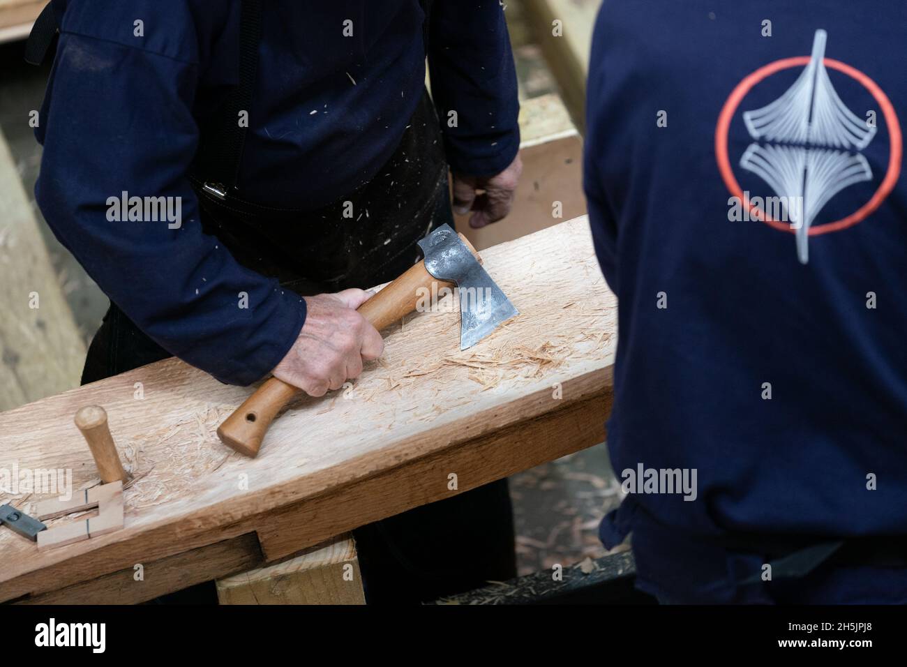 A team of volunteers work on the keel of the 88ft-long replica of the ...