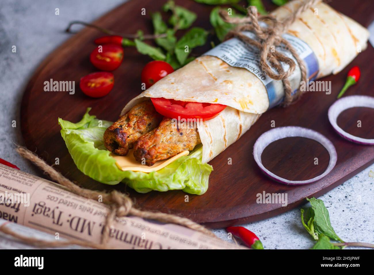Fresh chicken seekh roll with fresh tomatos, salad, cheese and onions ...