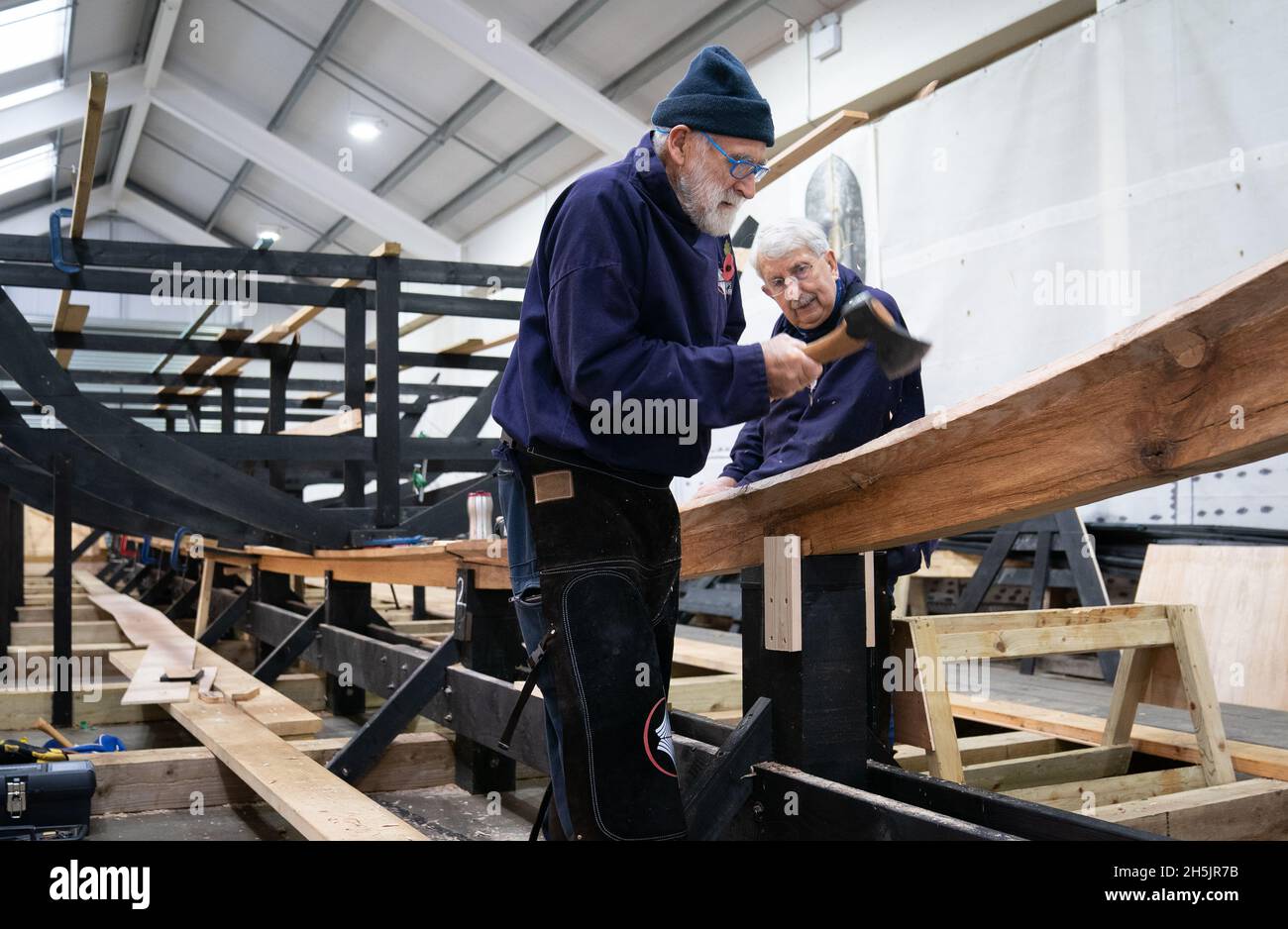 Bryan Knibbs (left) and David Turner work on the keel of the 88ft-long ...