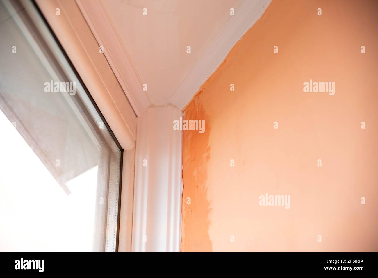 Rain dripping in the corner on the balcony between the window frame and ...