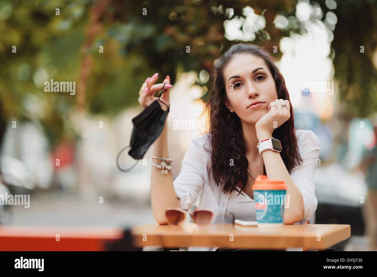 The young girl took off her mask. Freedom from the pandemic Stock Photo ...