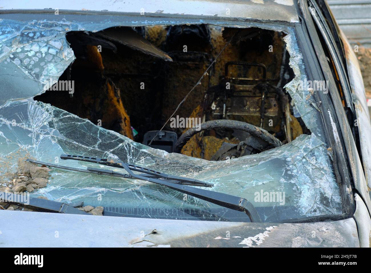 Broken and melted windshield of burnt out car after fire Stock Photo ...
