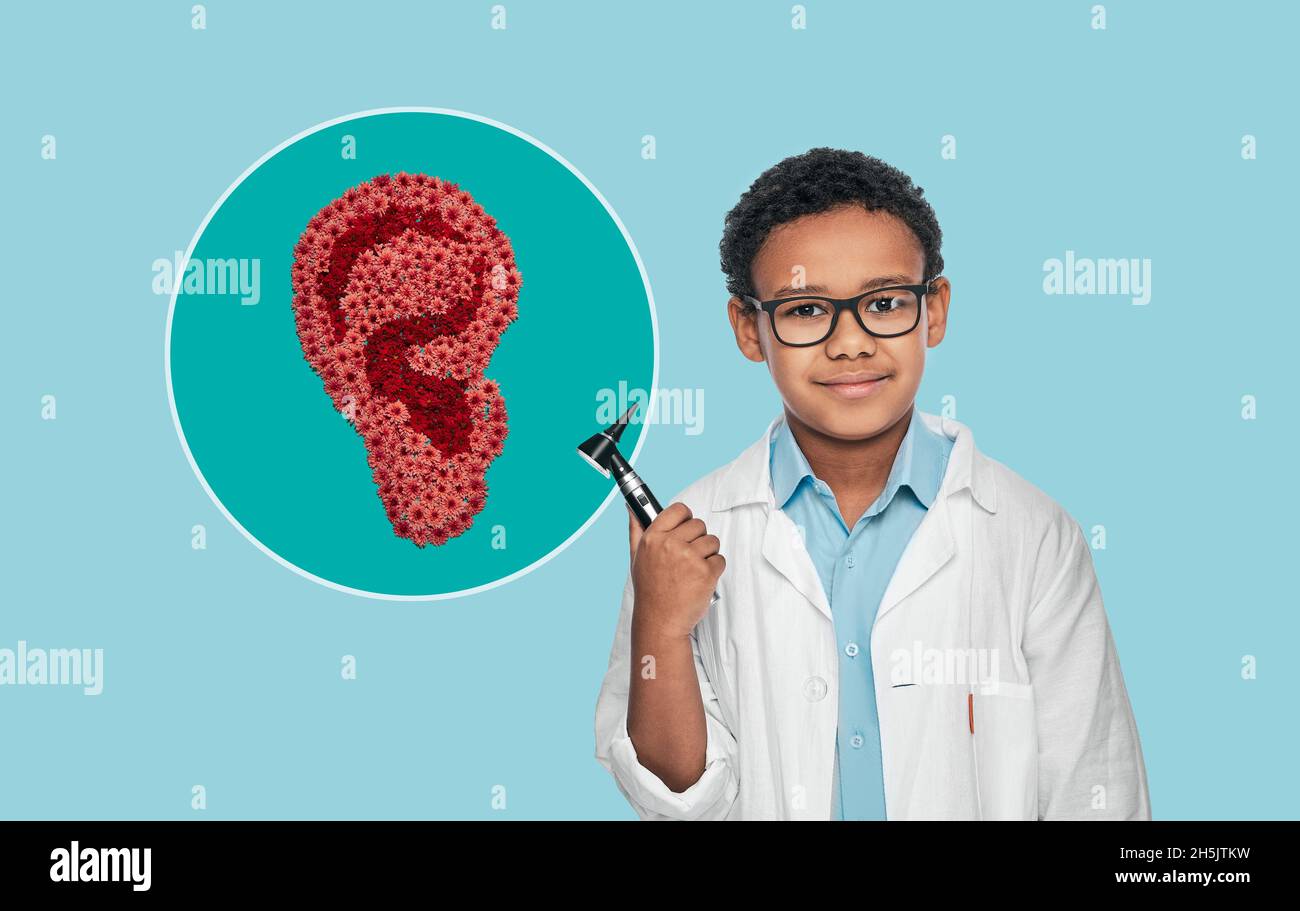 Hearing test in children. African American boy with otoscope playing ...