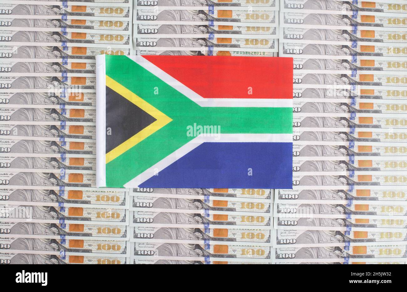 South Africa flag on a background from dollar banknotes. Concept of the ...