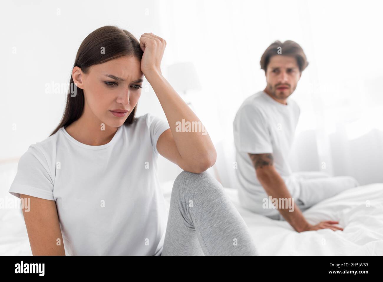 Sad millennial european husband with stubble looks at offended ...