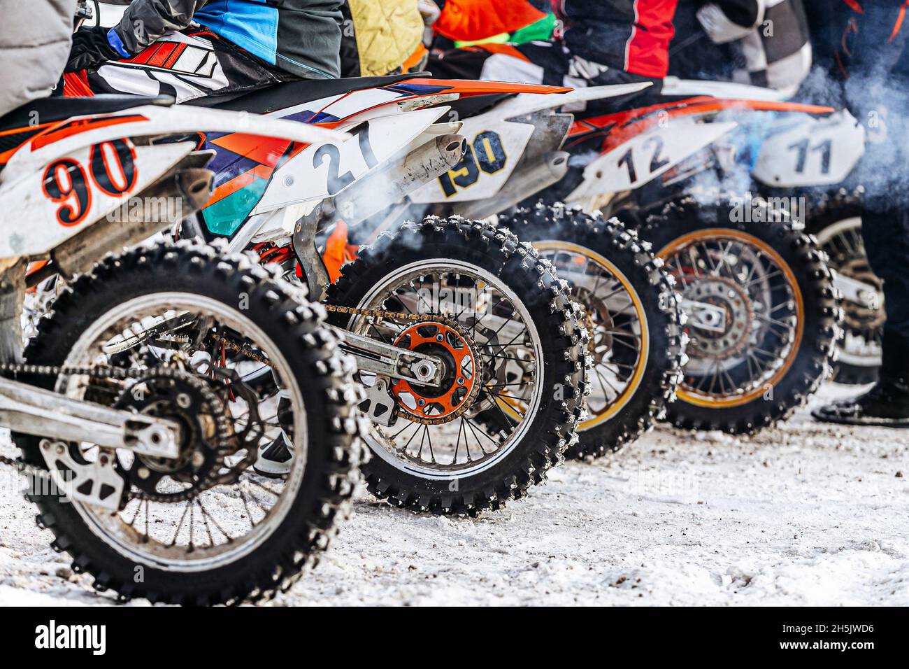 rear wheels motorcycles on start line winter motocross Stock Photo - Alamy