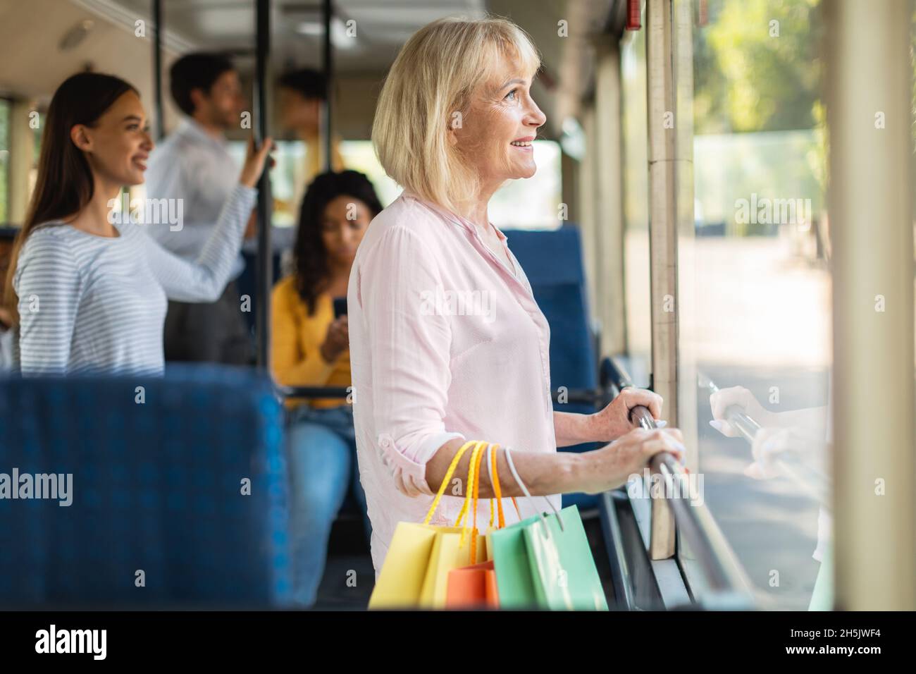 Public Transportation Concept. Portrait of smiling senior lady standing ...