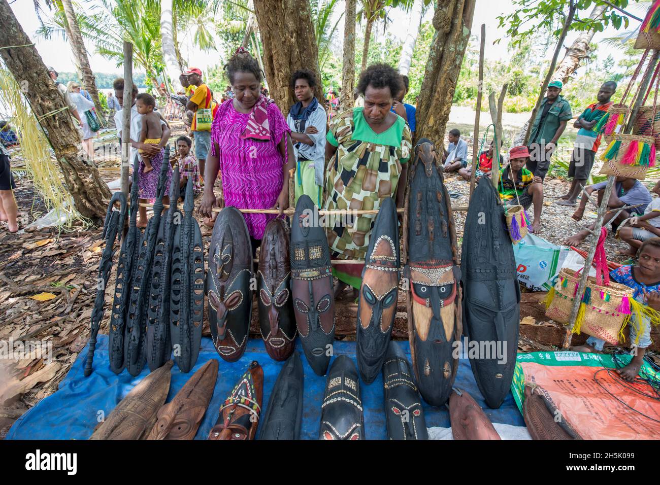 Masks made of carved wood and shells on sale in market in Mendam ...