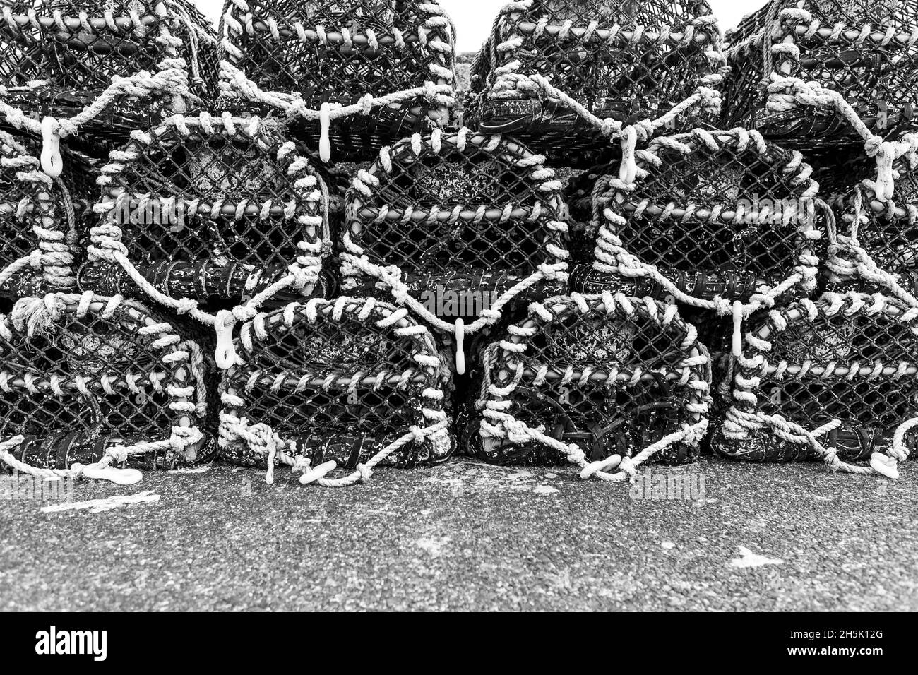 Lobster pots and fish boxes stacked outside a fish house. Newlyn ...