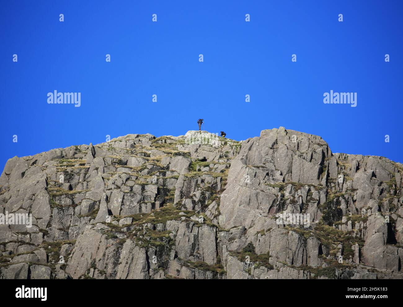 Two walkers on the summit of Pavey ark in the Lake district national ...
