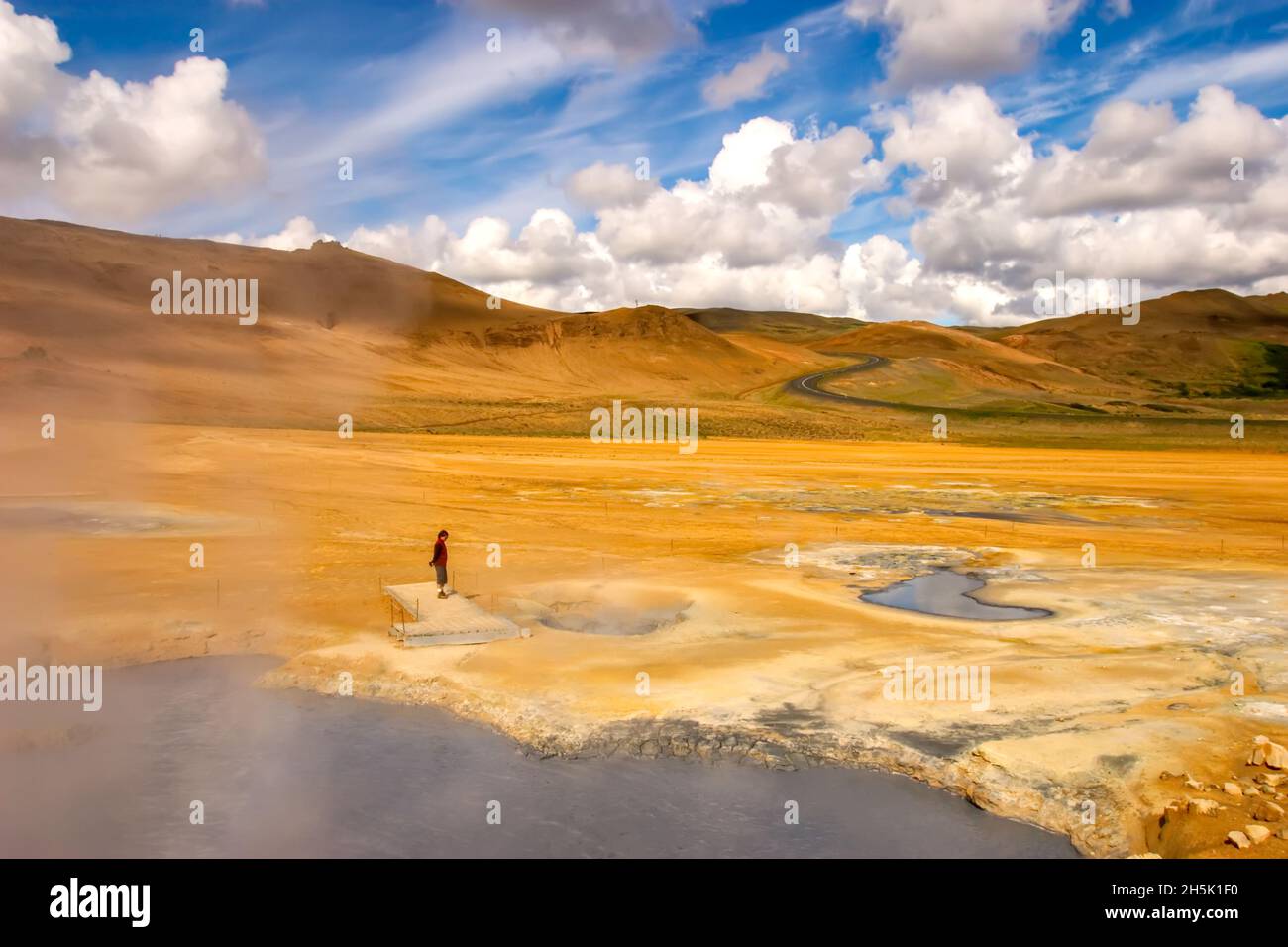 Tourist observing boiling mud pits, a source of alternative enegry ...
