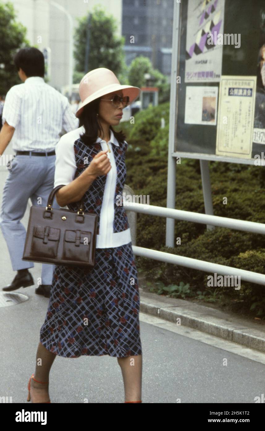 A woman walks down the street, Japan, 1970s Stock Photo - Alamy