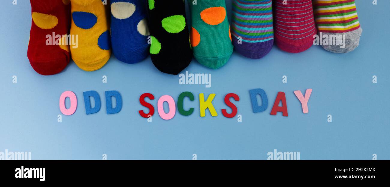 Odd Socks Day. Day lost socks, lonely socks on blue background Stock ...