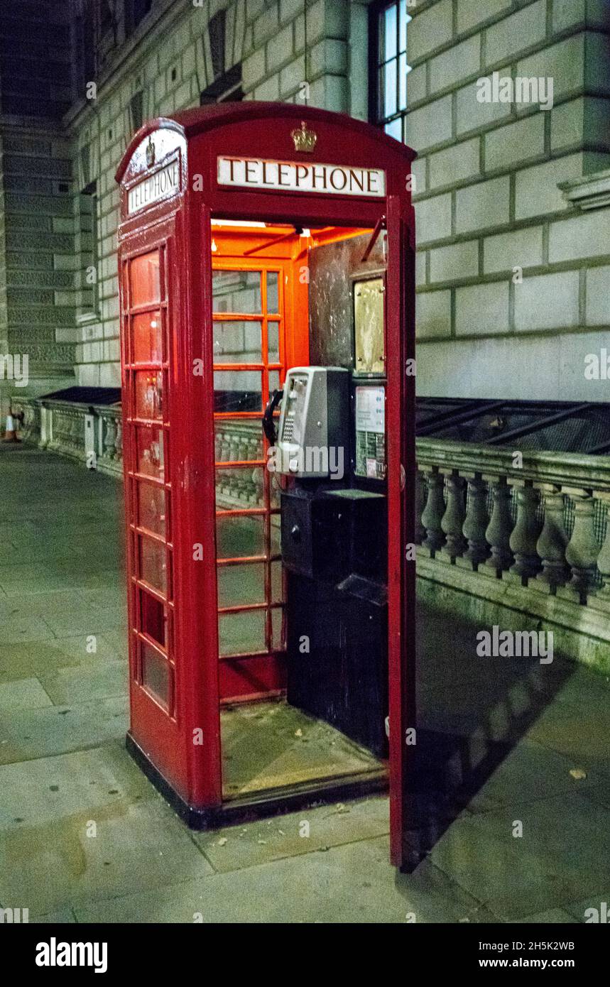 A traditional red telephone box at night in London Stock Photo - Alamy