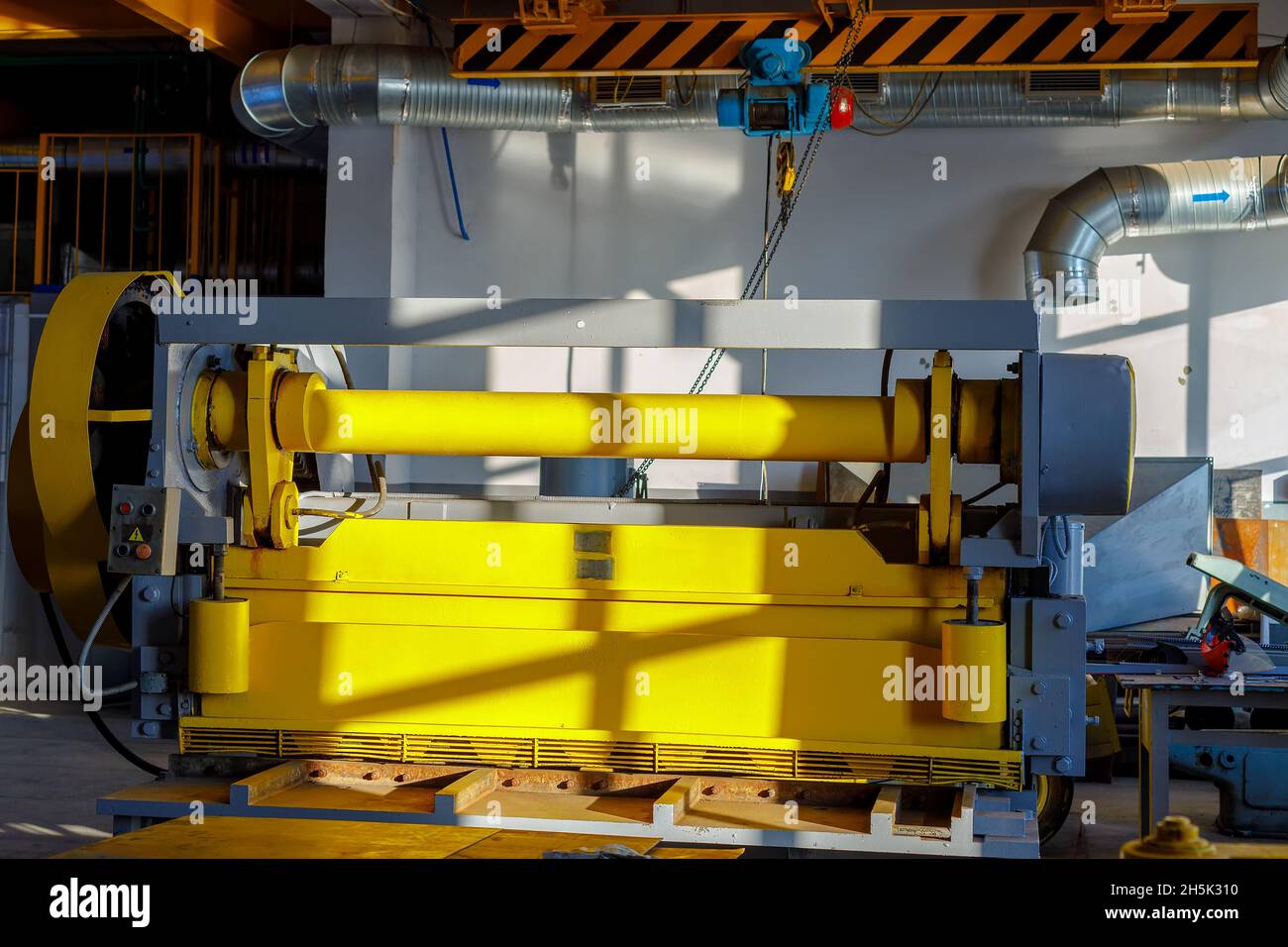 Machine for cutting metal is in production hall. Industrial background ...