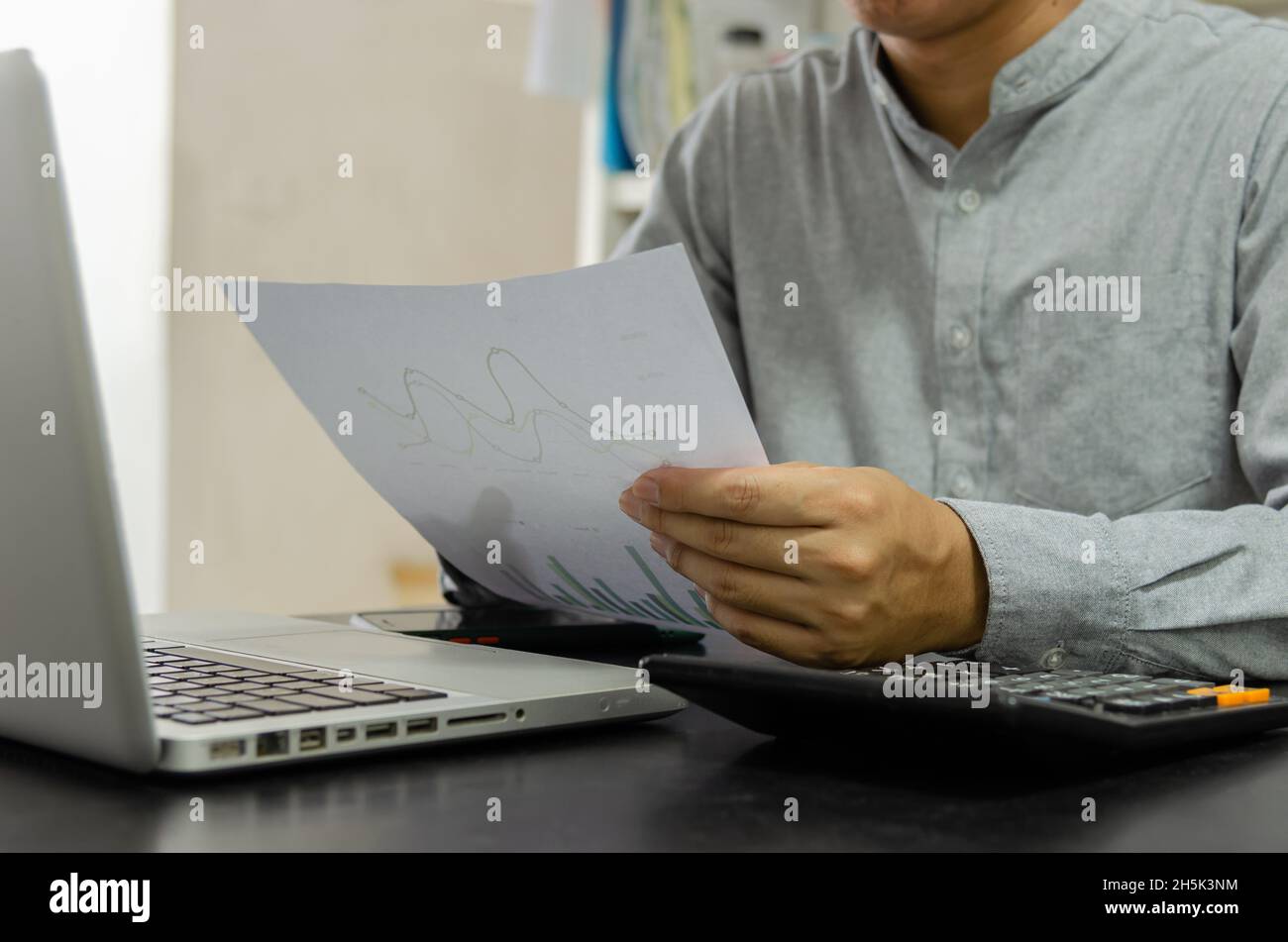 Business Man using calculator at a desk. Business finance, tax, and ...